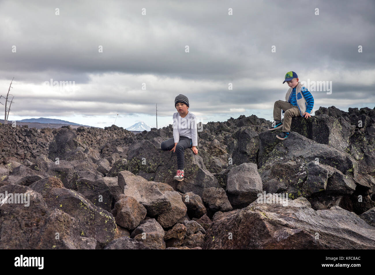 Two children playing on rocks hi-res stock photography and images - Alamy