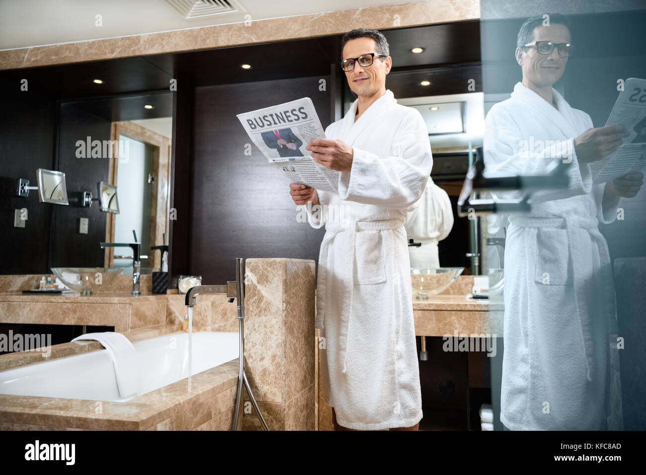 Man wearing bathrobe standing hi-res stock photography and images - Alamy