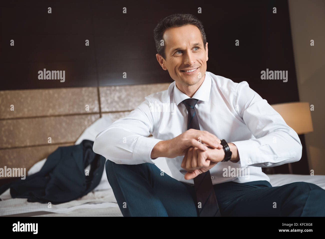businessman sitting on bed Stock Photo - Alamy
