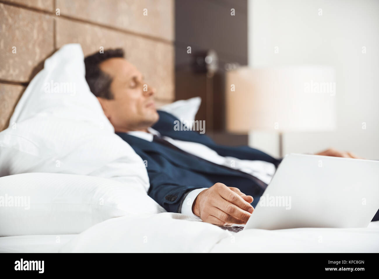 Businessman napping in hotel room Stock Photo - Alamy