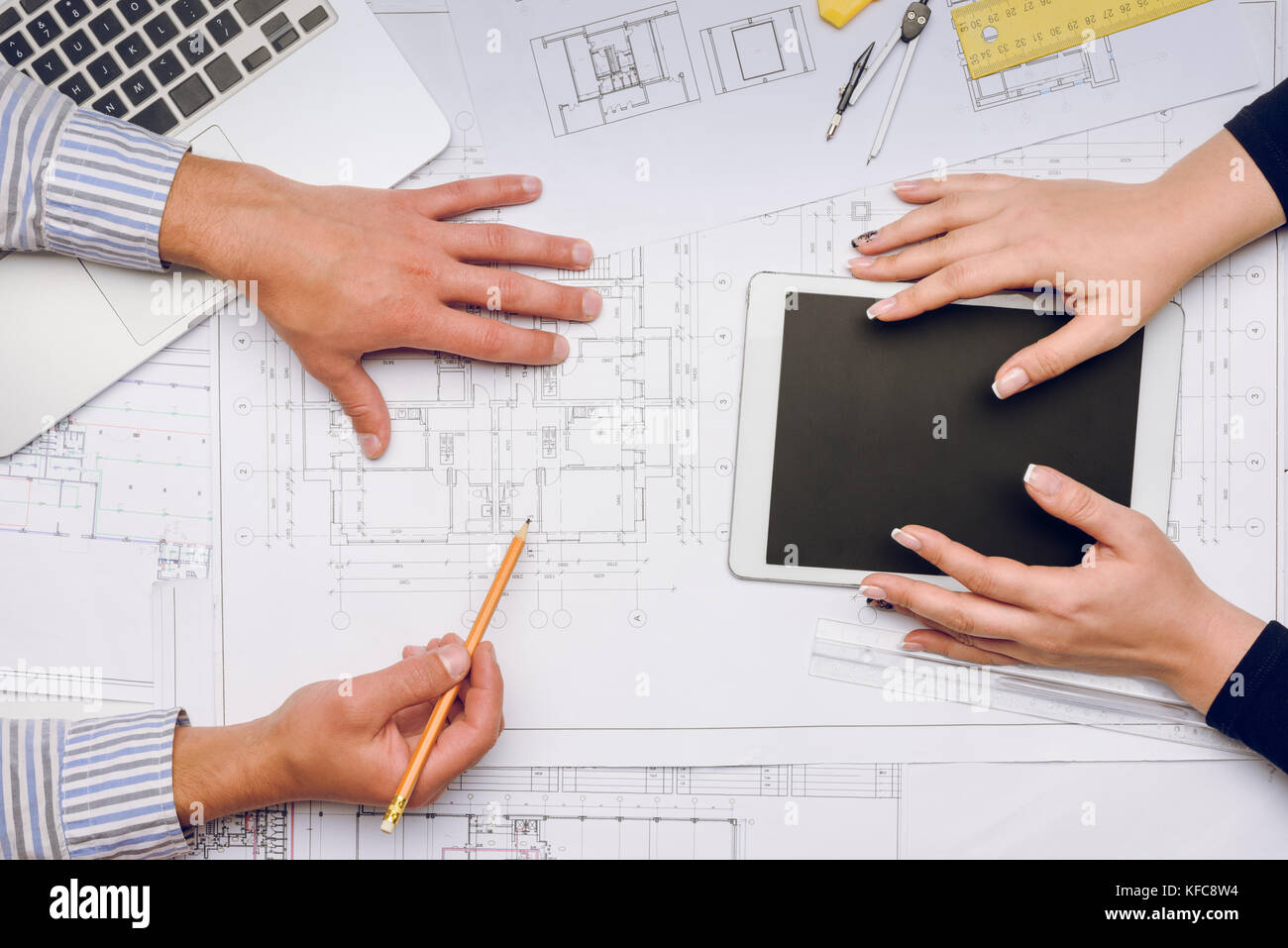 architects at workplace with blueprints Stock Photo - Alamy