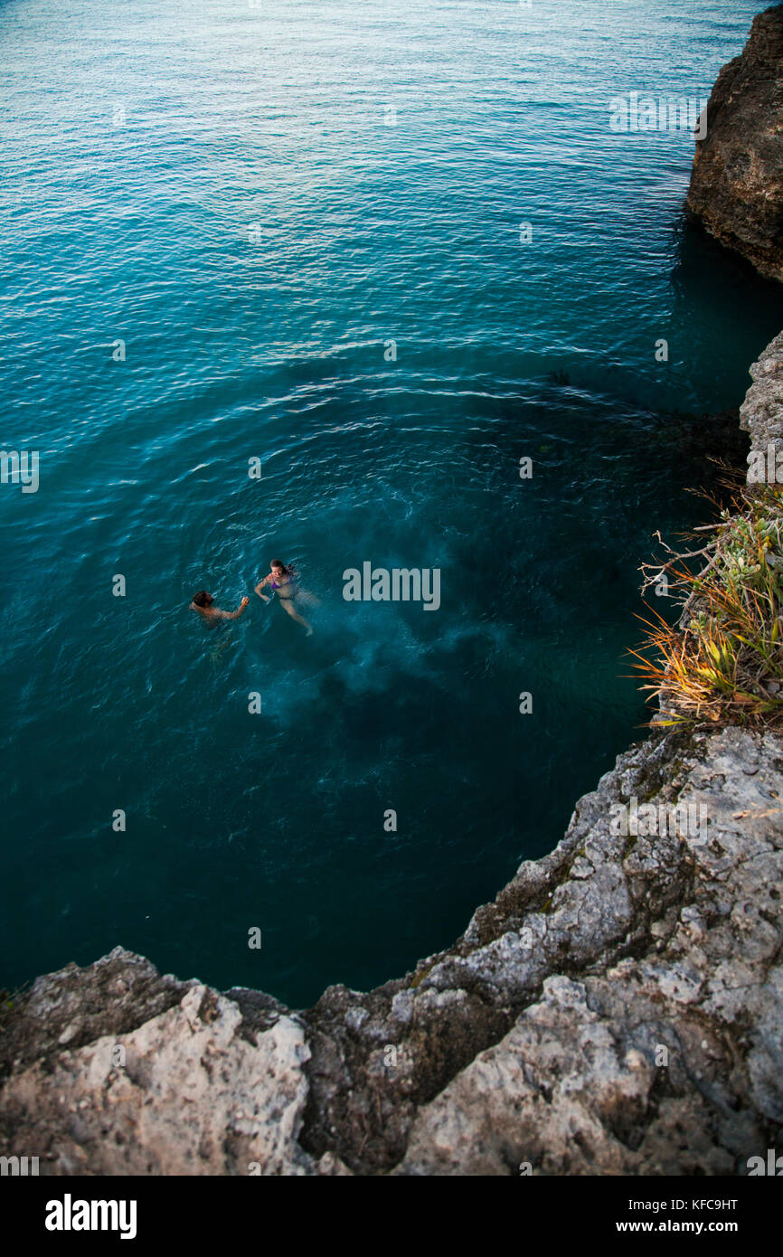 BERMUDA. Hamilton Parish. Cliff jumping, swimming off a point in ...