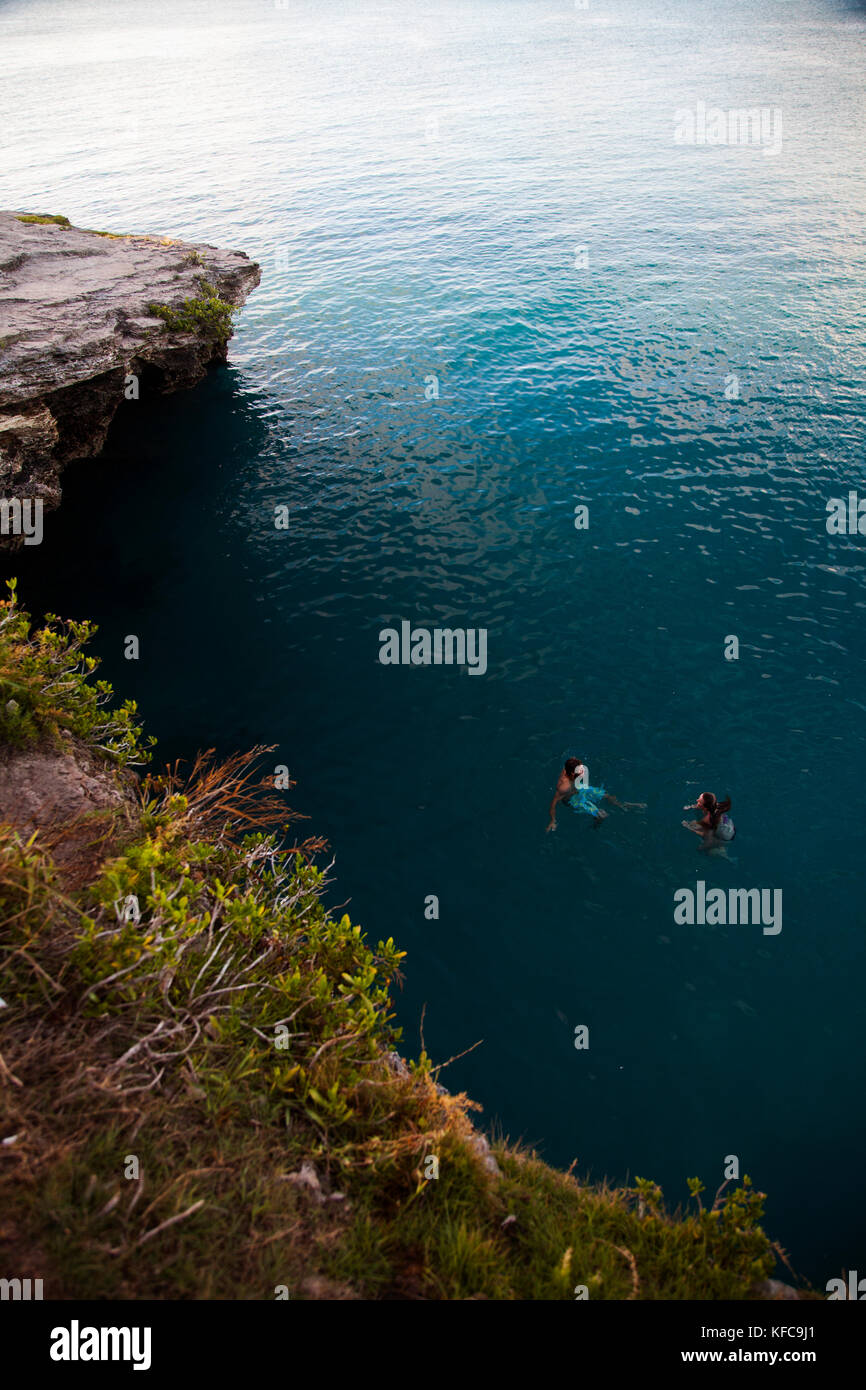 BERMUDA. Hamilton Parish. Cliff jumping, swimming off a point in ...