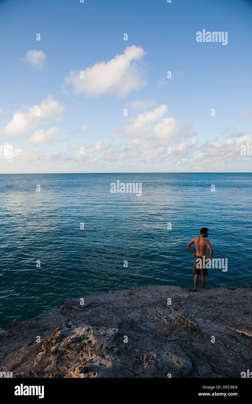 BERMUDA. Hamilton Parish. Cliff jumping, swimming off a point in ...