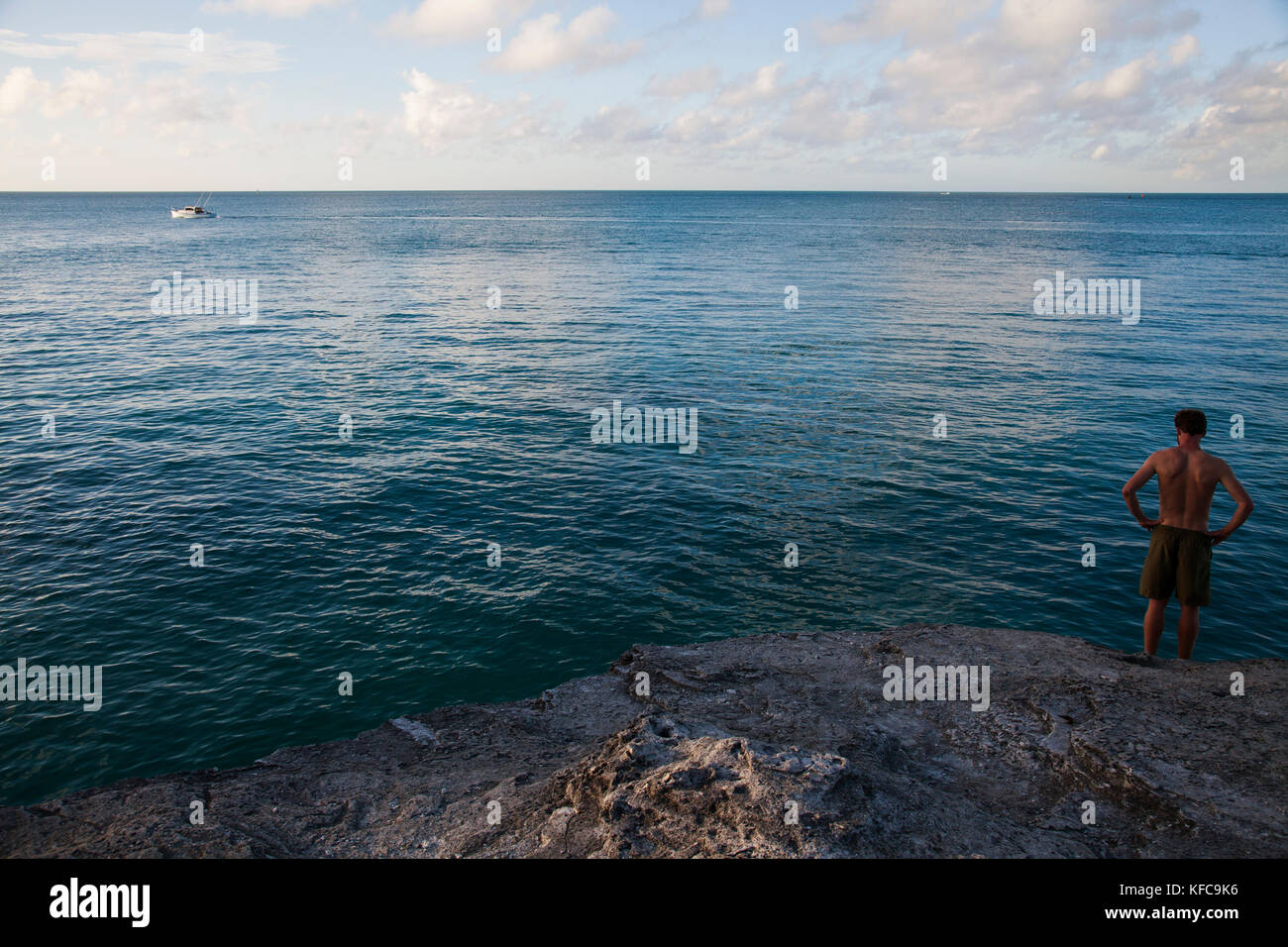 BERMUDA. Hamilton Parish. Cliff jumping, swimming off a point in ...