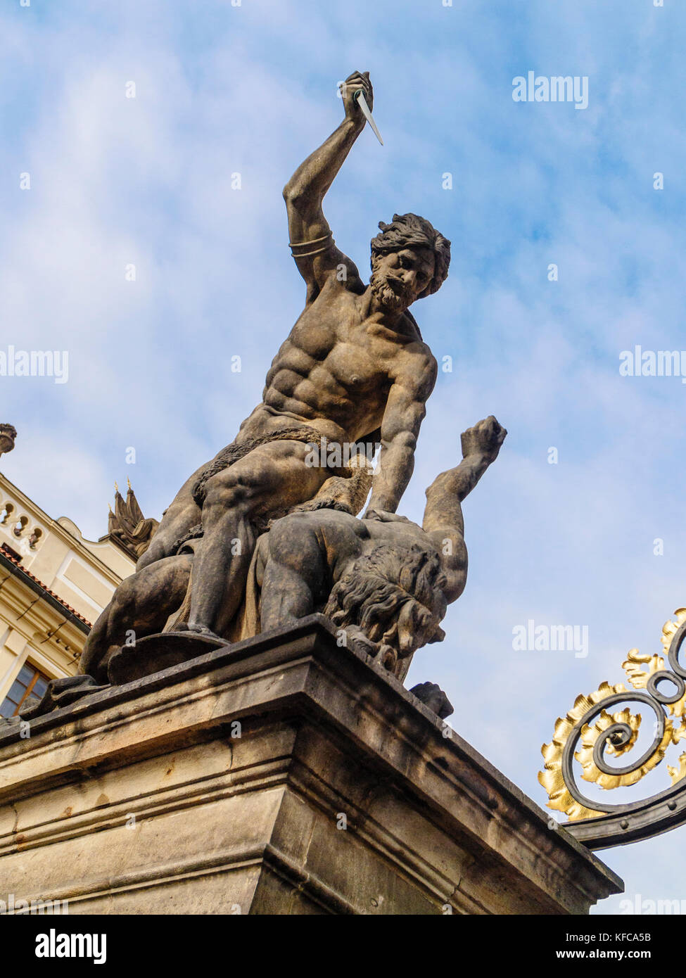 Statue of a battling Titan with a dagger at the gate of Hradcany Castle ...