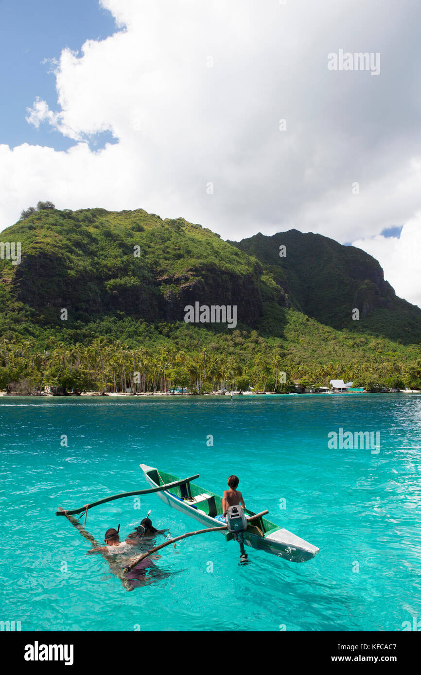 FRENCH POLYNESIA, Moorea Island. A family spearfishing at Opunohu Bay ...