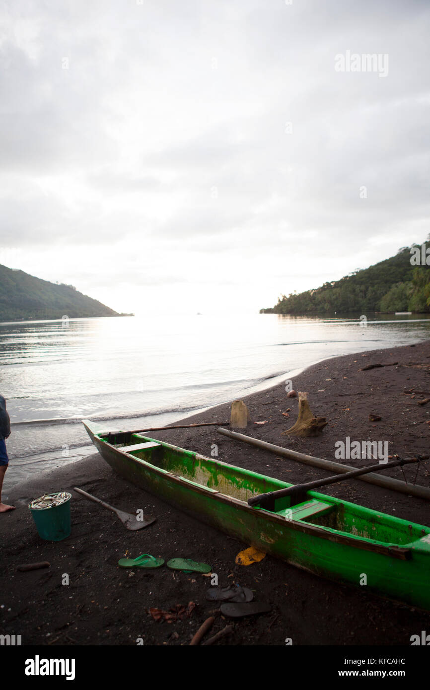FRENCH POLYNESIA, Moorea. A fishing boat on a beach at sunset Stock ...