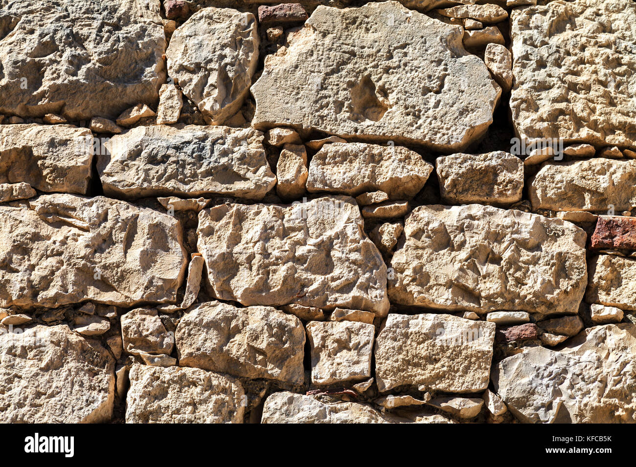 Wall made of stones of different shapes and sizes. Background Stock ...
