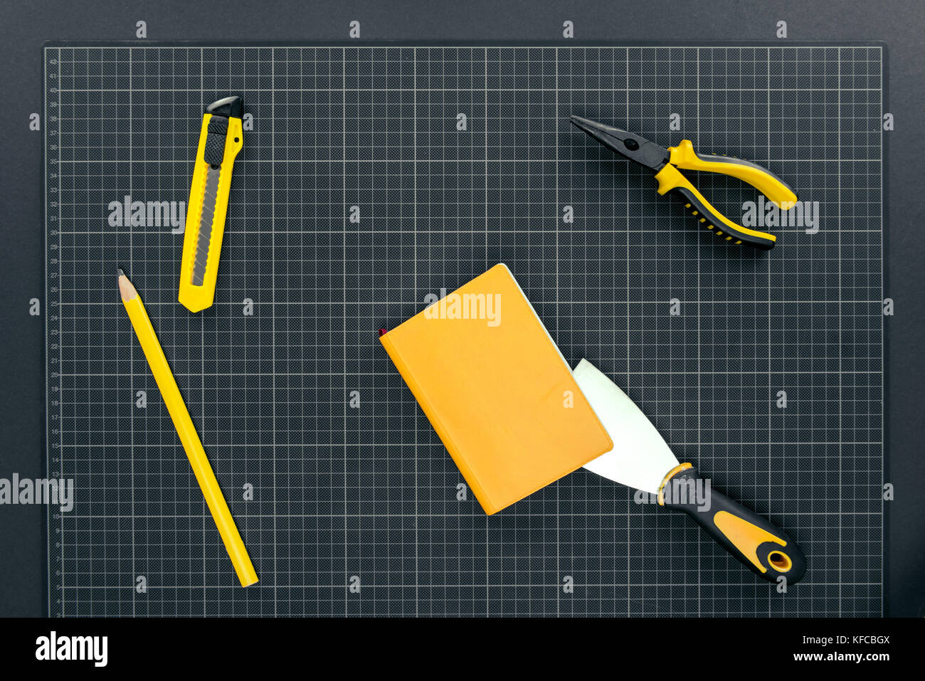 Notebook and tools on graph paper Stock Photo - Alamy