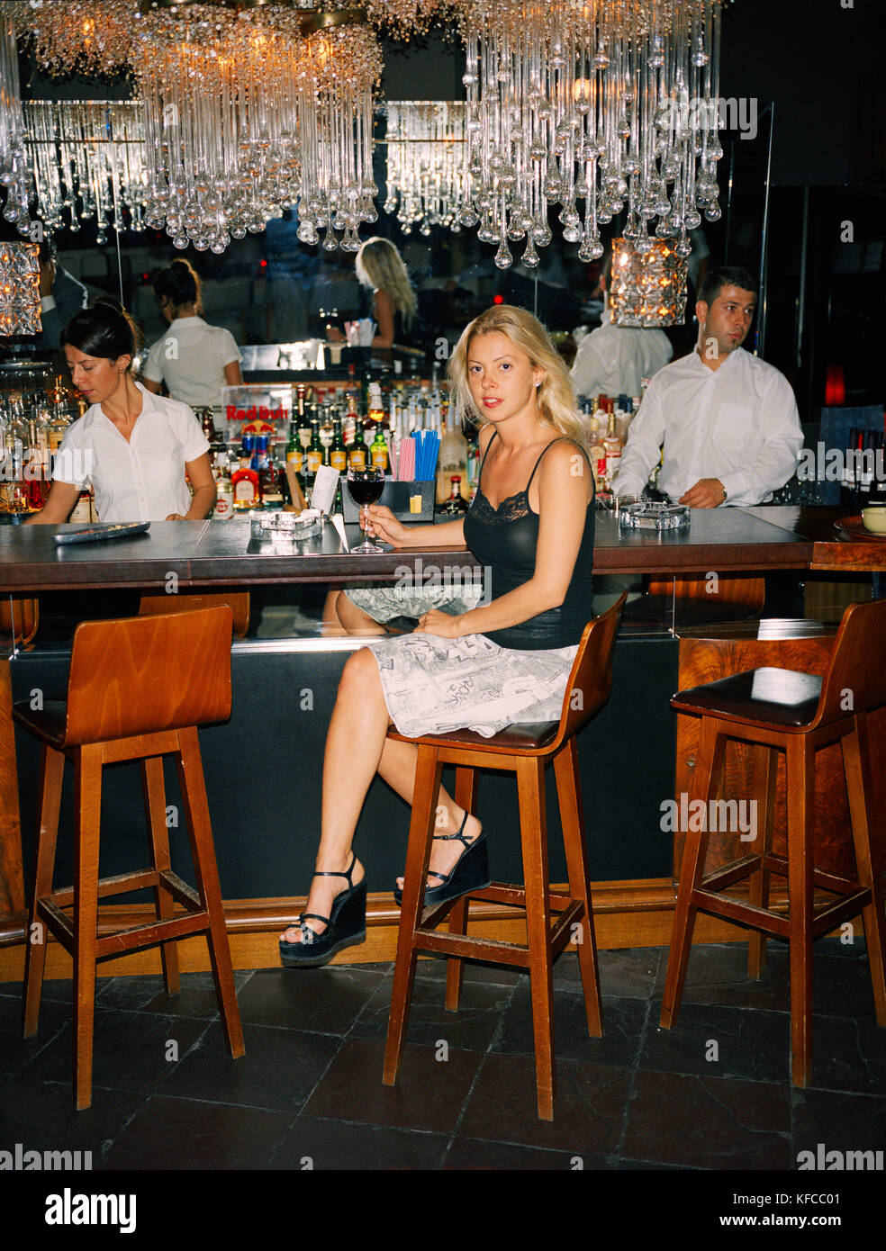 TURKEY, Istanbul, portrait of young female sitting at bar counter in ...