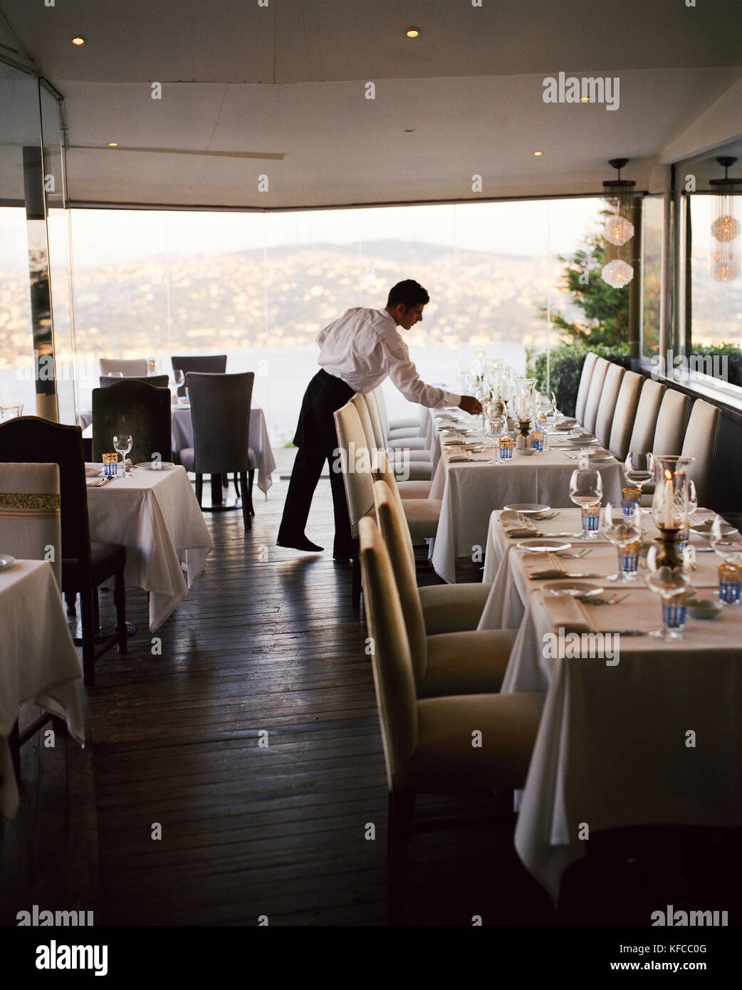 TURKEY, Istanbul, waiter arranging plates and glasses in Ulus 29 ...