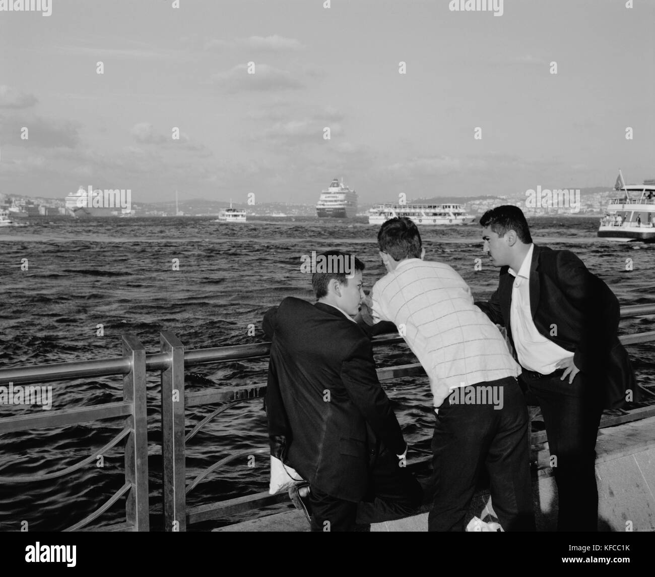 TURKEY, Istanbul, rear view of people waiting for the ferry (B&W Stock ...