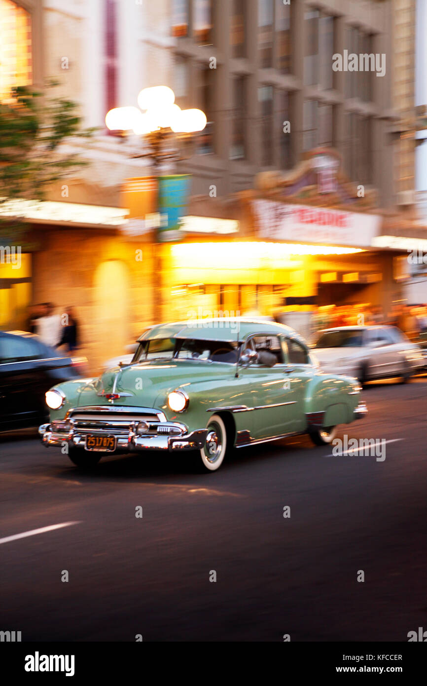USA, California, San Diego, old cars speed off down the road near 5th ...