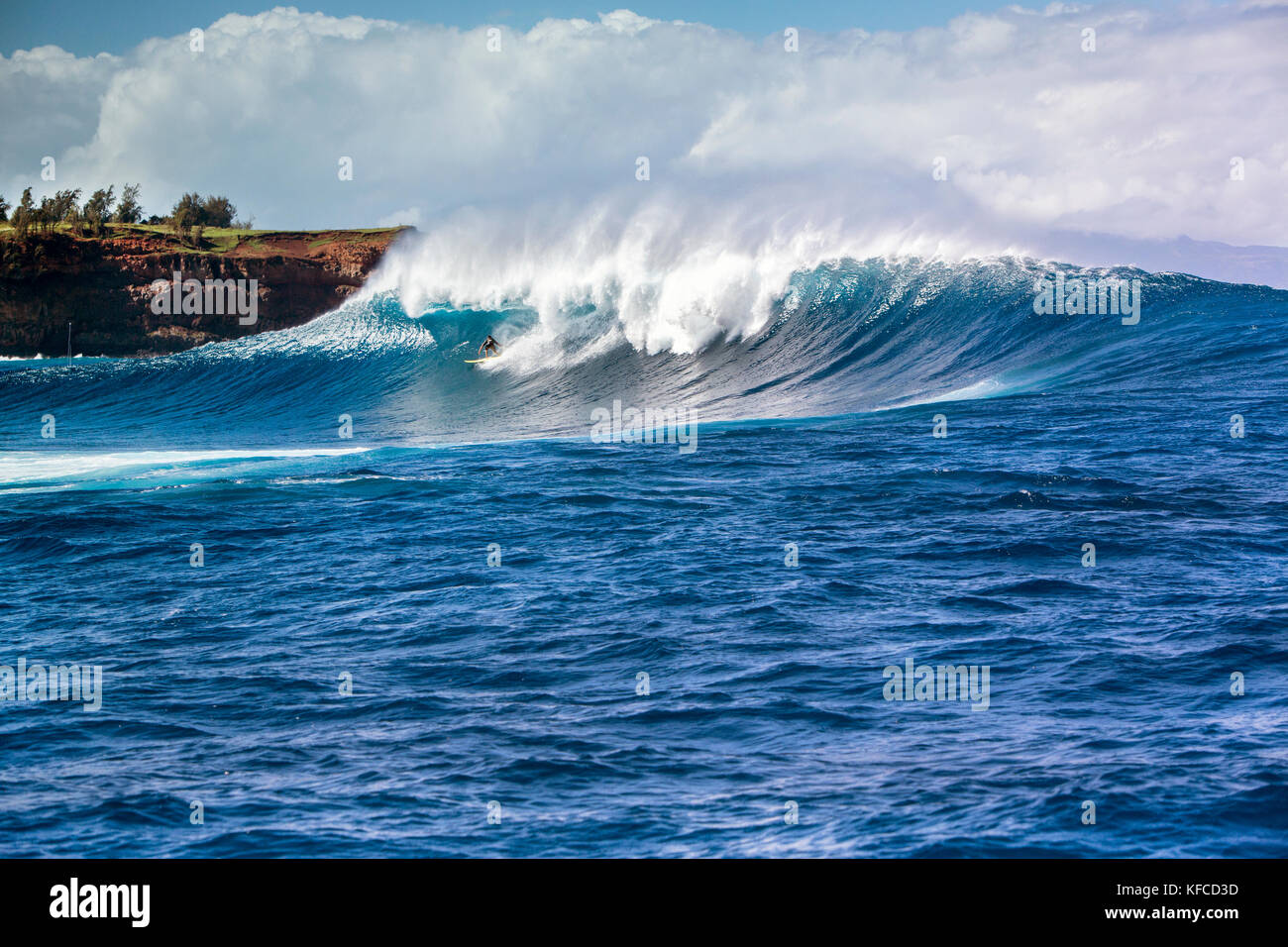 USA, HAWAII, Maui, Jaws, big wave surfers taking off on a wave at Peahi ...