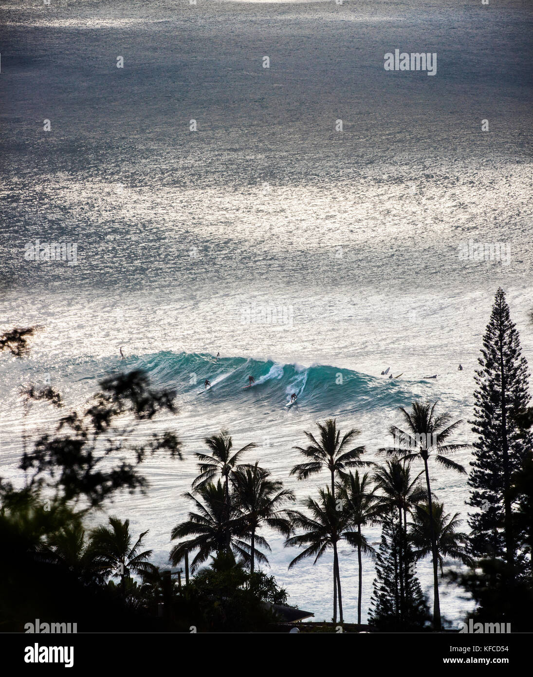 HAWAII, Oahu, North Shore, surfers in the water at Waimea Bay Stock ...