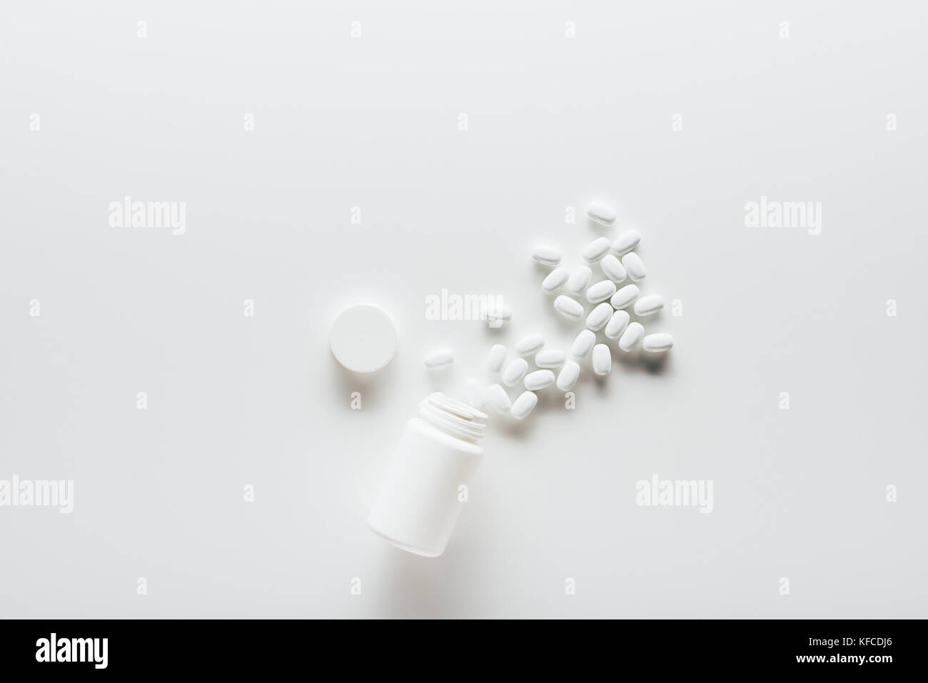 white pills and container Stock Photo - Alamy