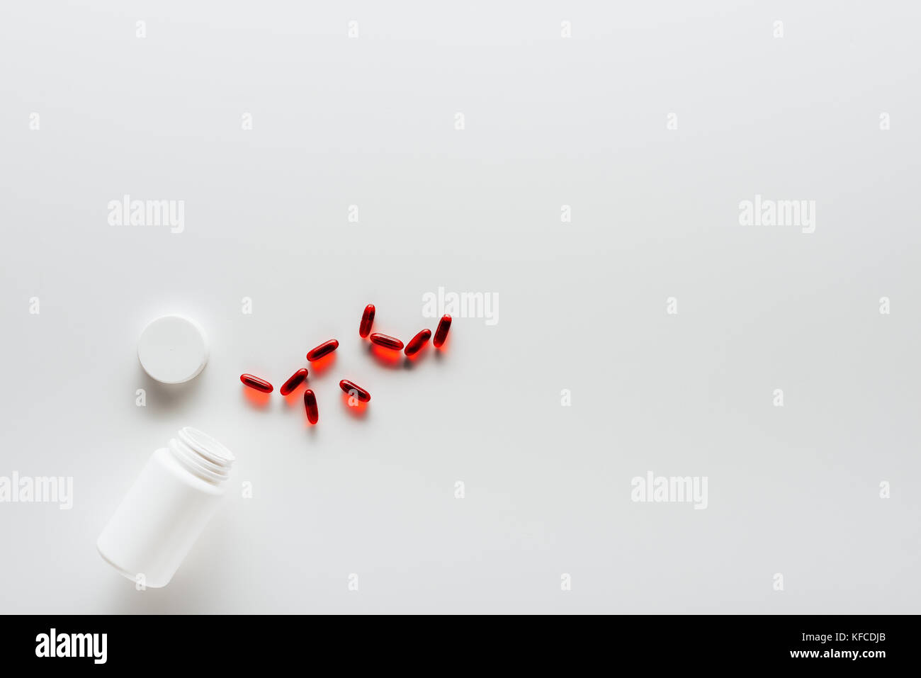 red capsules and container Stock Photo - Alamy