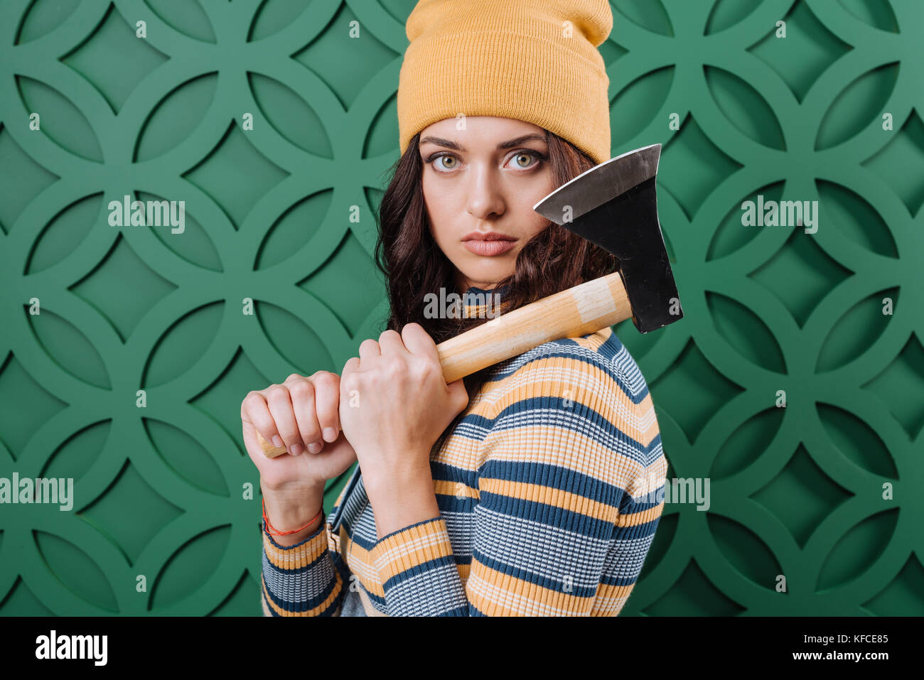 Woman standing with axe in hands Stock Photo - Alamy