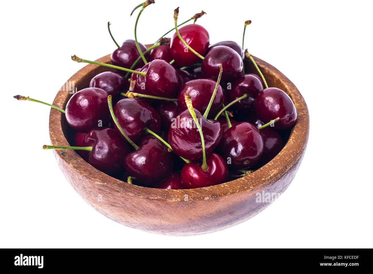 Red, ripe, sweet cherry in wooden bowl, isolated on white background ...
