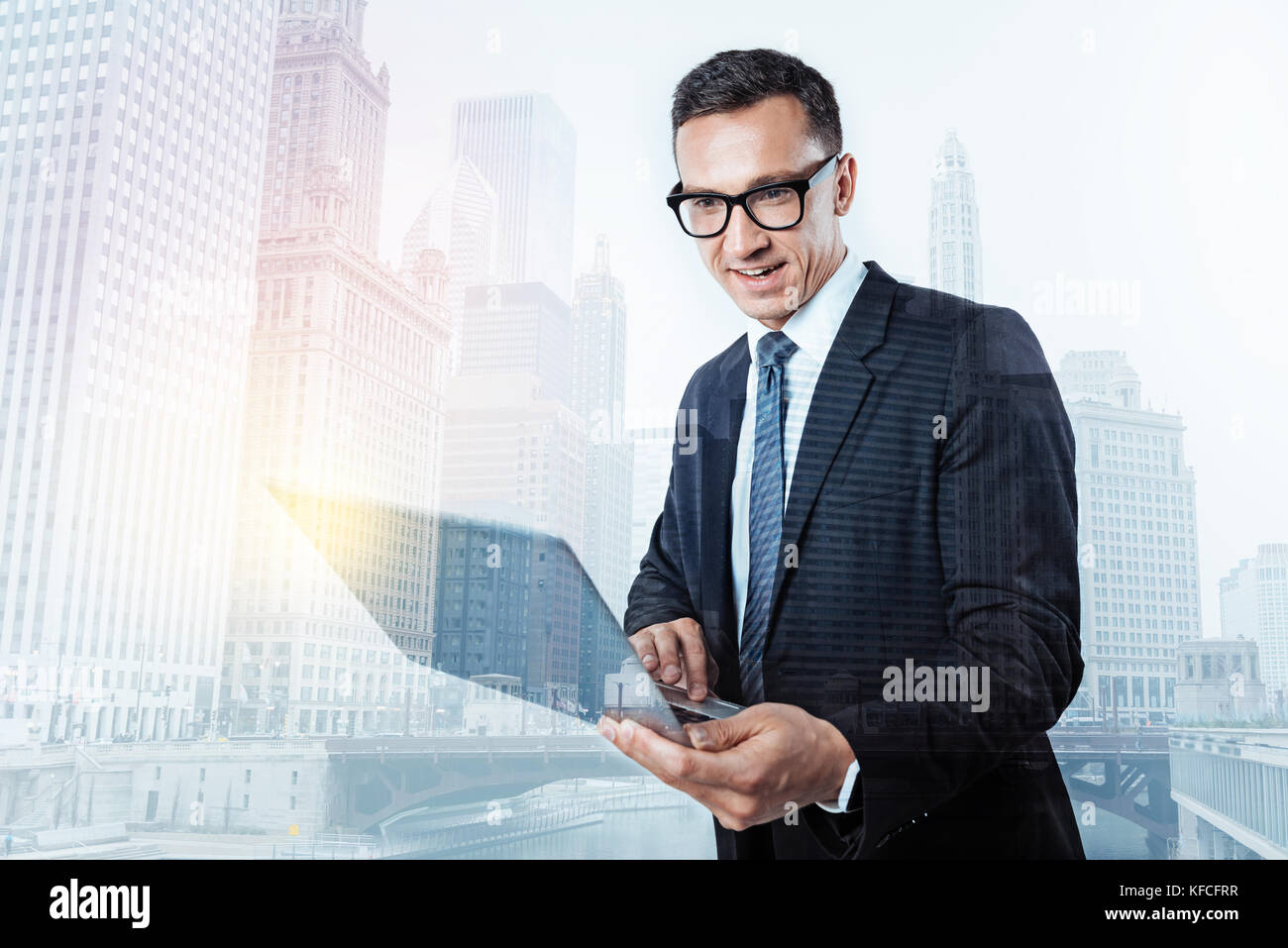 Joyful handsome man using a laptop Stock Photo - Alamy