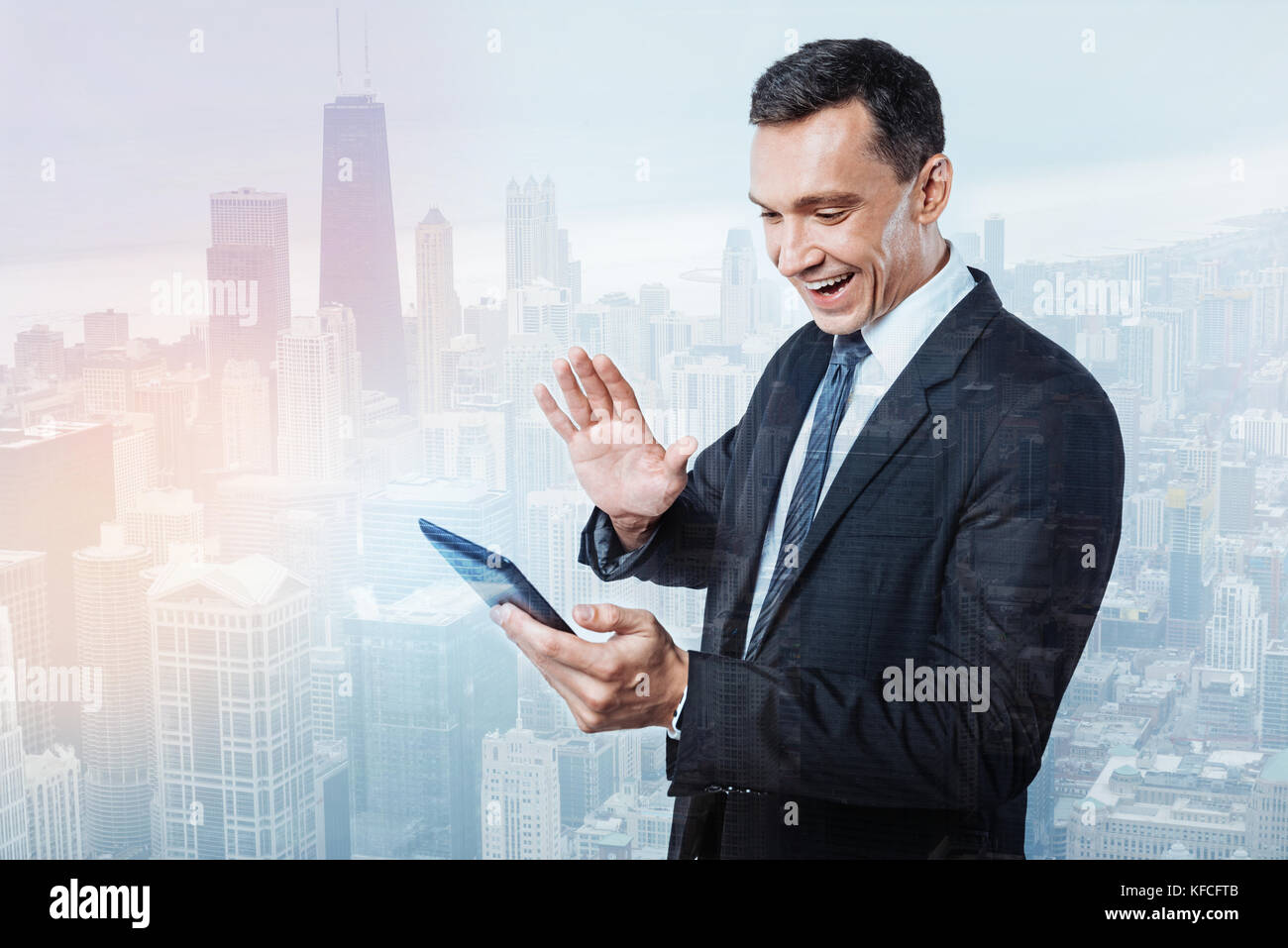 Positive delighted man making a video call Stock Photo - Alamy
