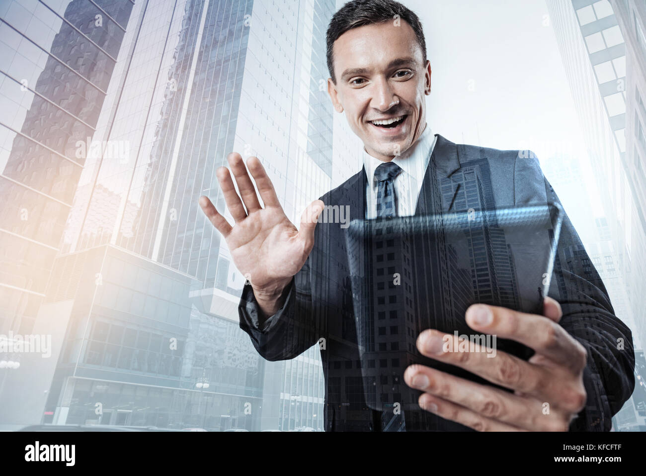 Happy handsome man waving his hand Stock Photo - Alamy