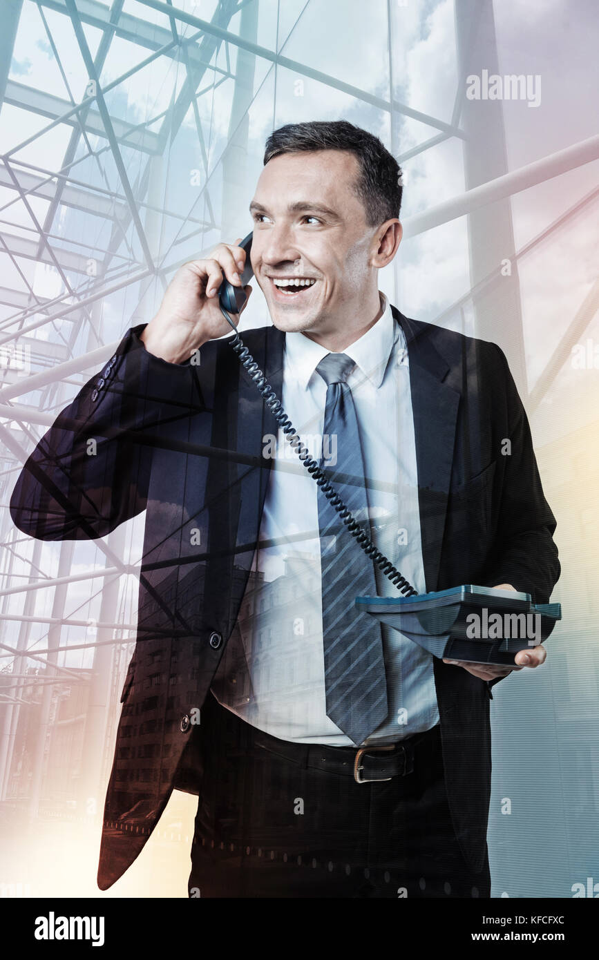 Joyful delighted man making a phone call Stock Photo - Alamy