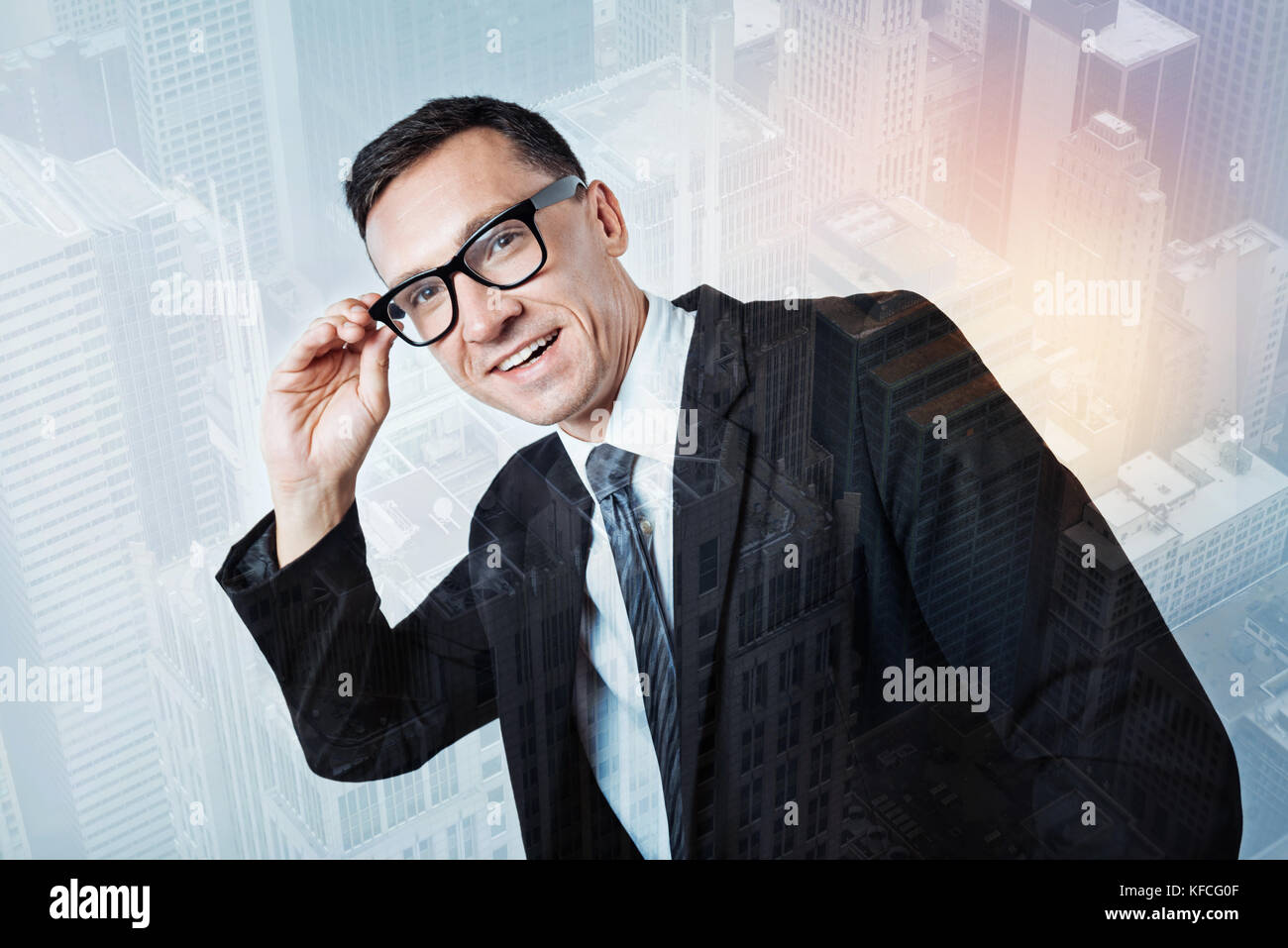 Joyful positive man fixing his glasses Stock Photo - Alamy Joyful positive man fixing his glasses Stock Photo - Alamy