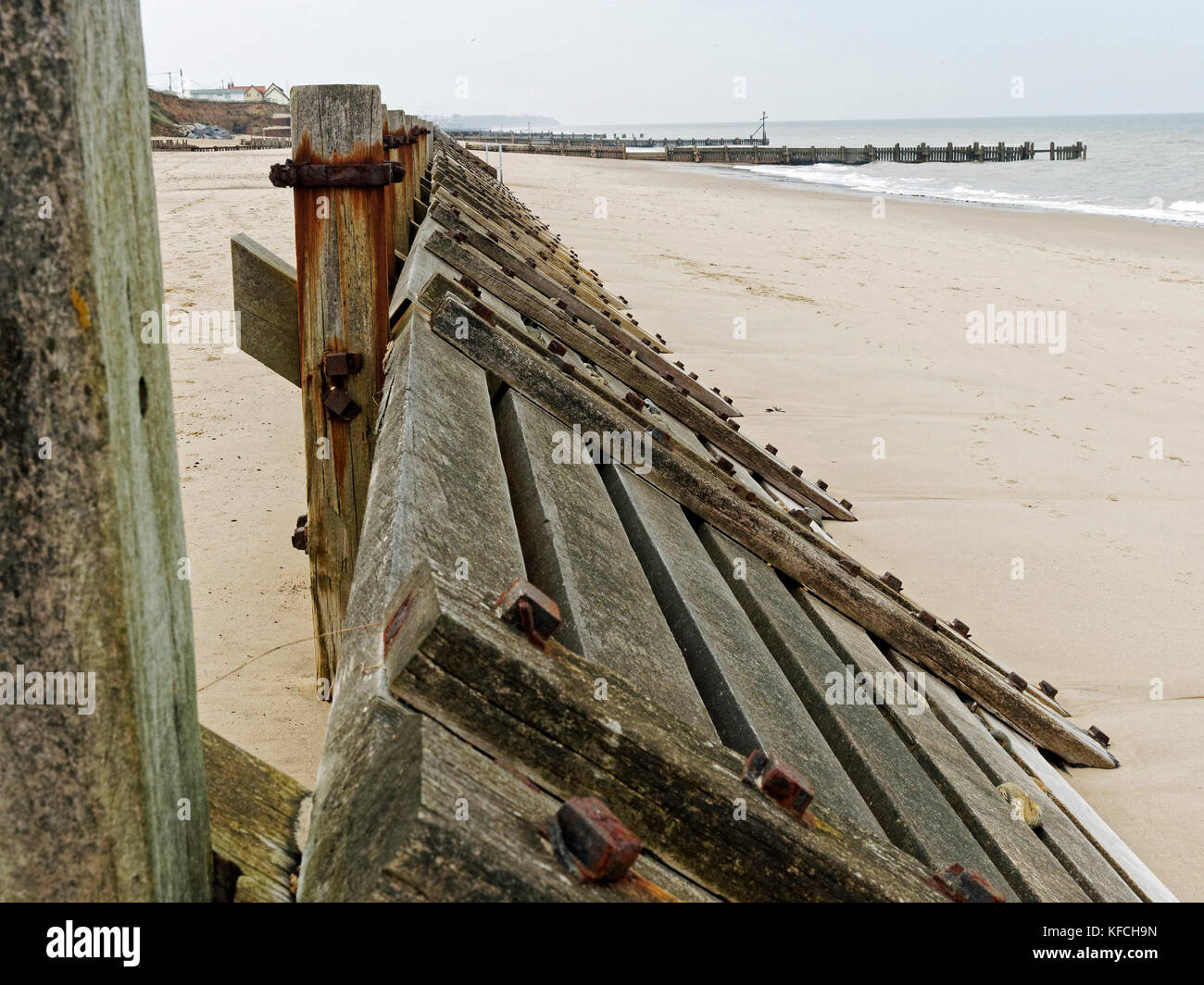 A sloped timber wall or groyne designed to break the strength of waves ...