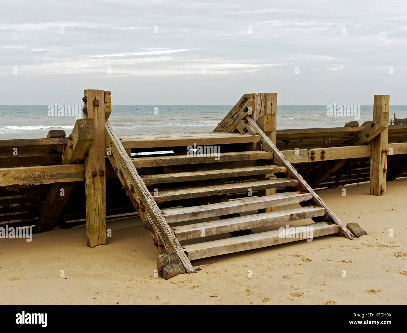 A sloped timber wall or groyne designed to break the strength of waves ...