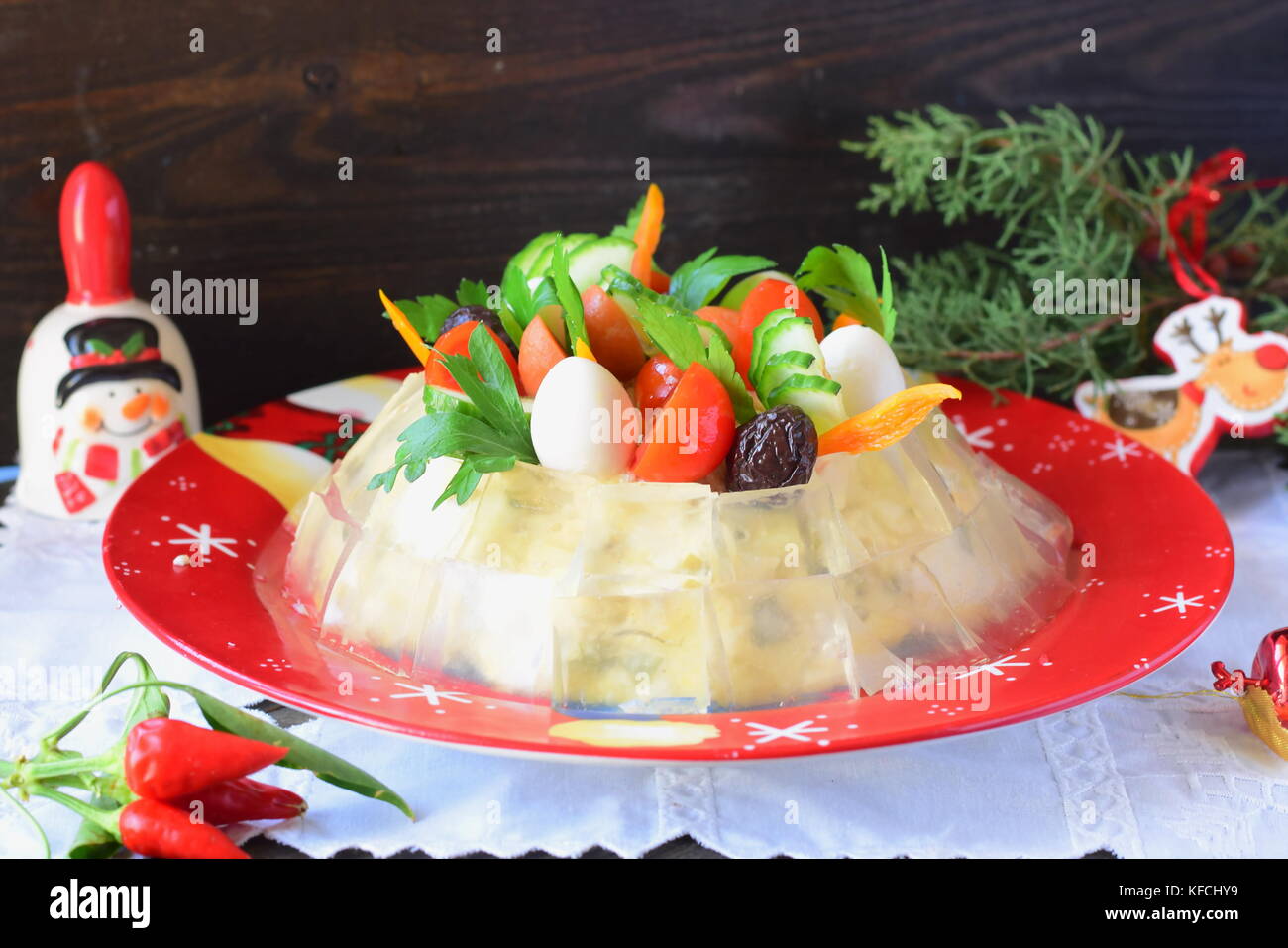 Traditional Russian meat salad with a jelly cubes coat, decorated with ...