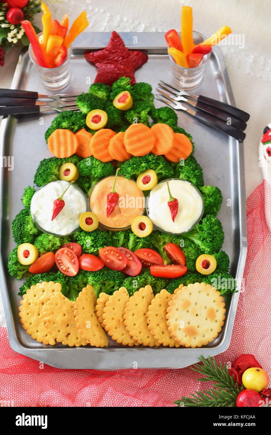 Christmas tree from a fresh vegetables, crisps and sauces. Vegan ...