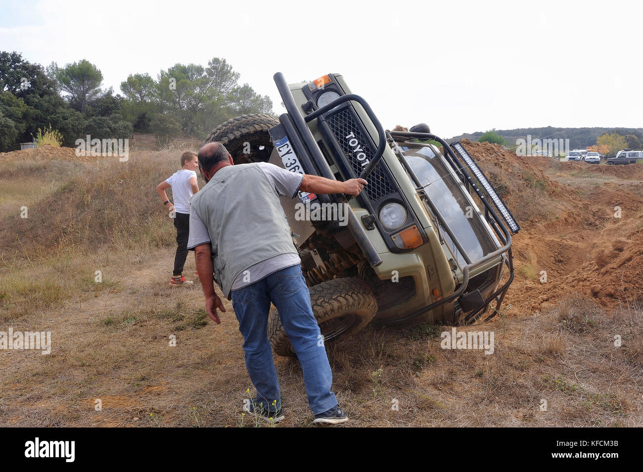 All-terrain car lying on the side after a risky and retightened ...
