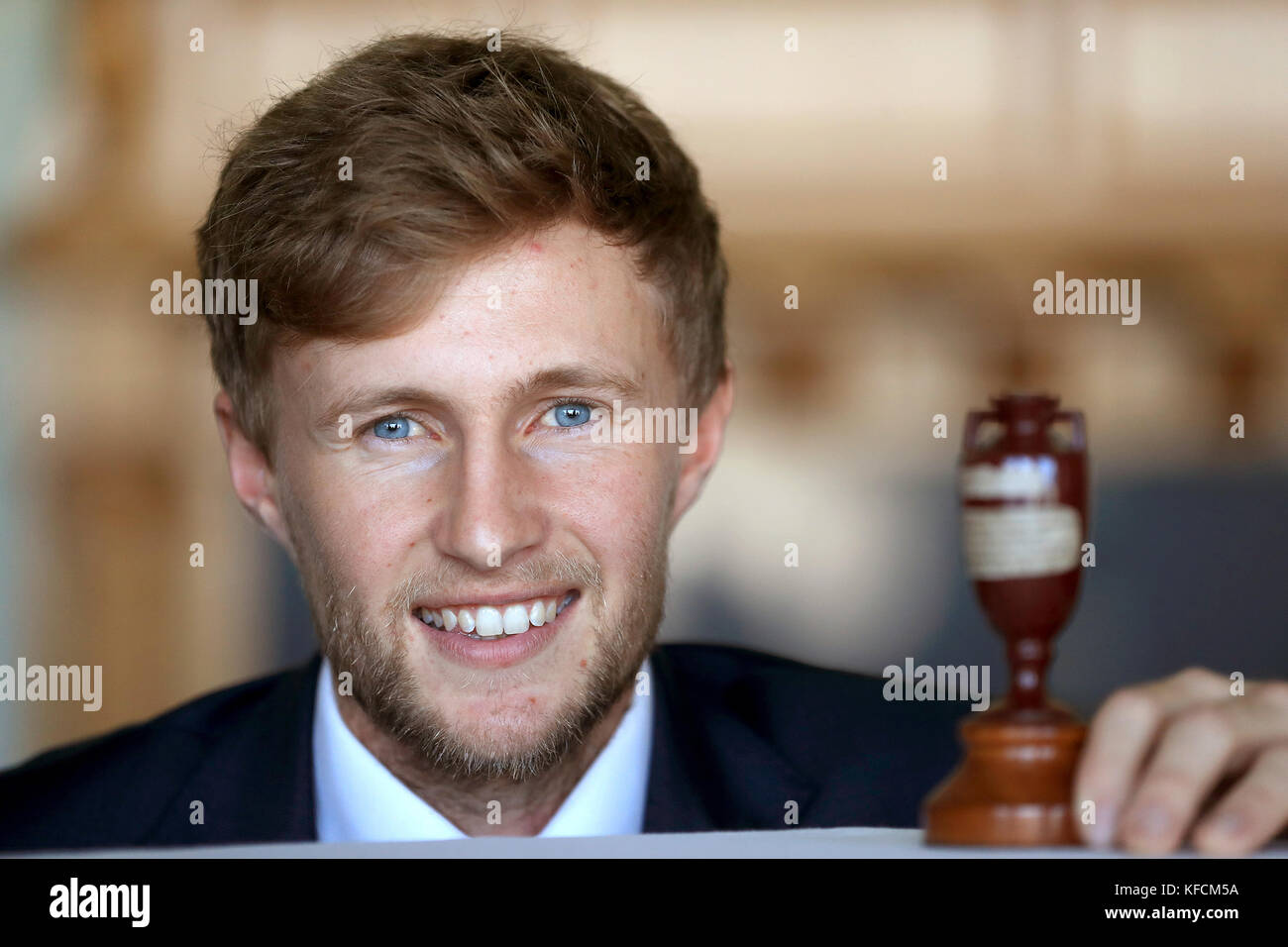 England's Joe Root holds the trophy during the press conference at Lord ...