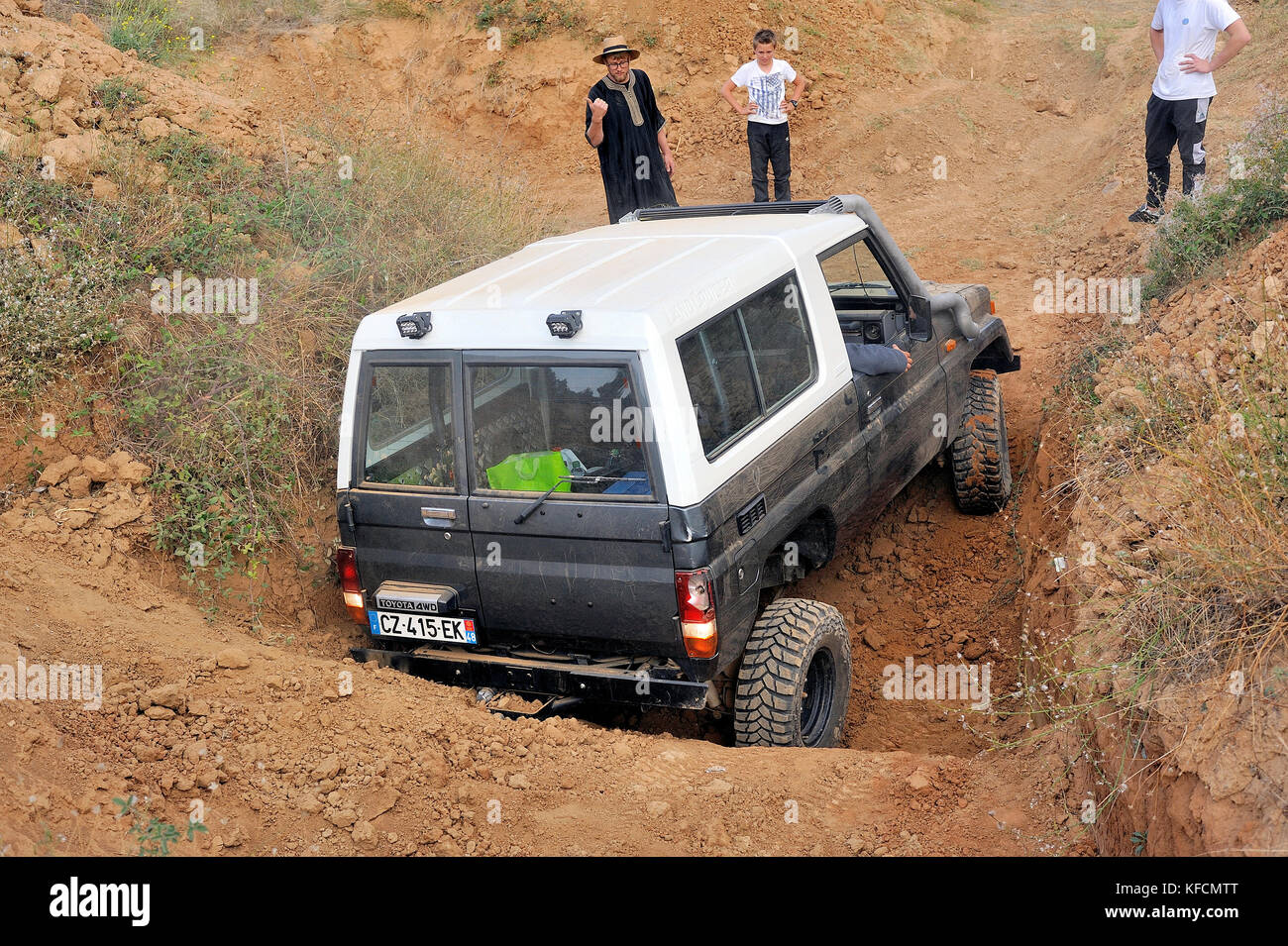 Large excavator digging hole sparks cars on trial grounds Stock Photo ...