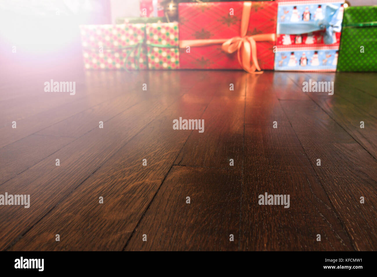 Gifts in a row are made under the Christmas tree Stock Photo - Alamy