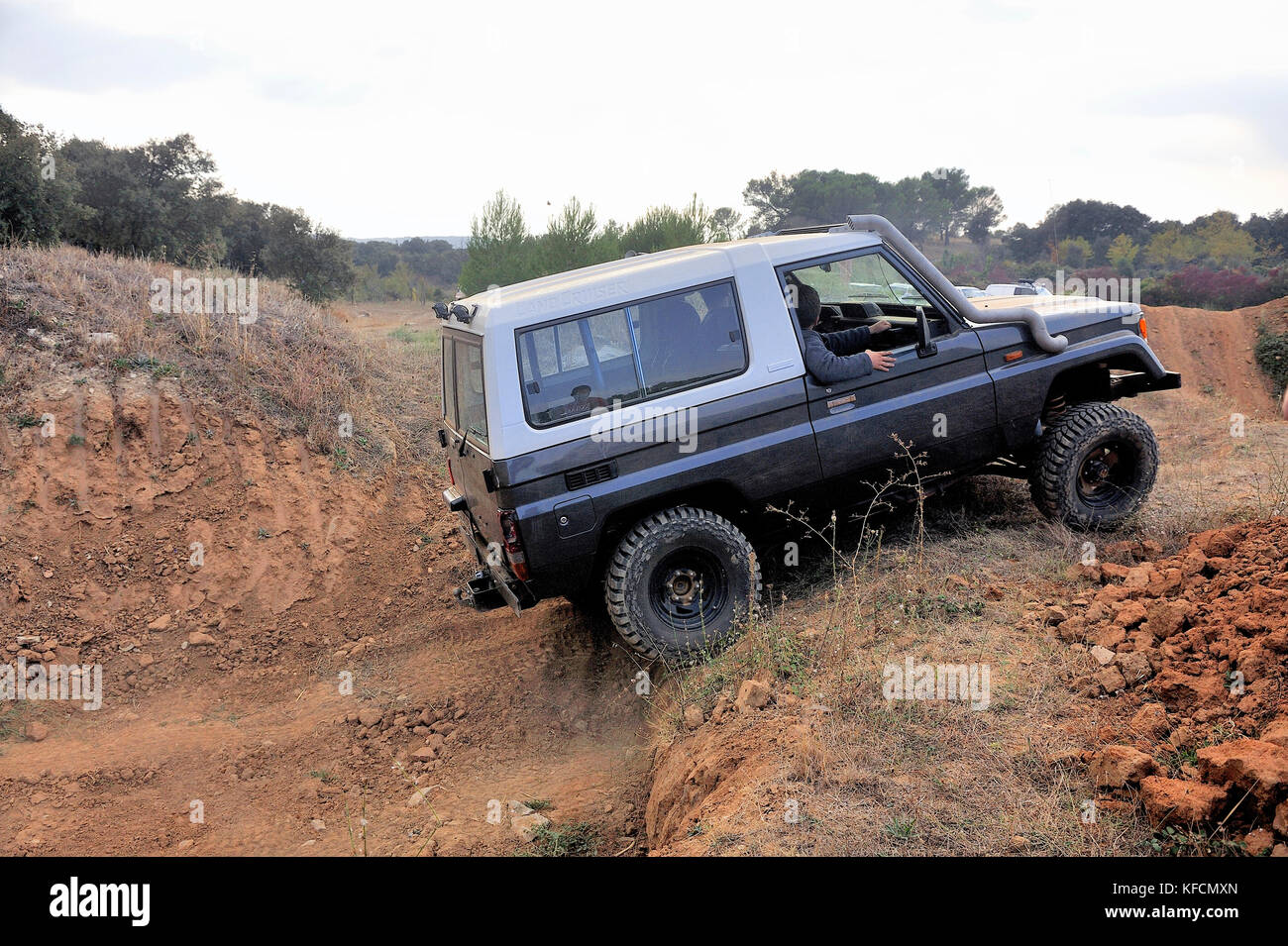 Large excavator digging hole sparks cars on trial grounds Stock Photo ...