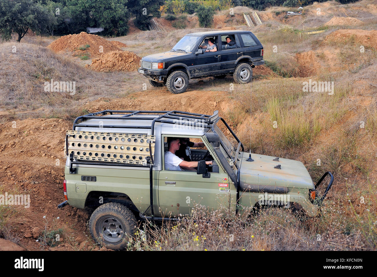 Large excavator digging hole sparks cars on trial grounds Stock Photo ...