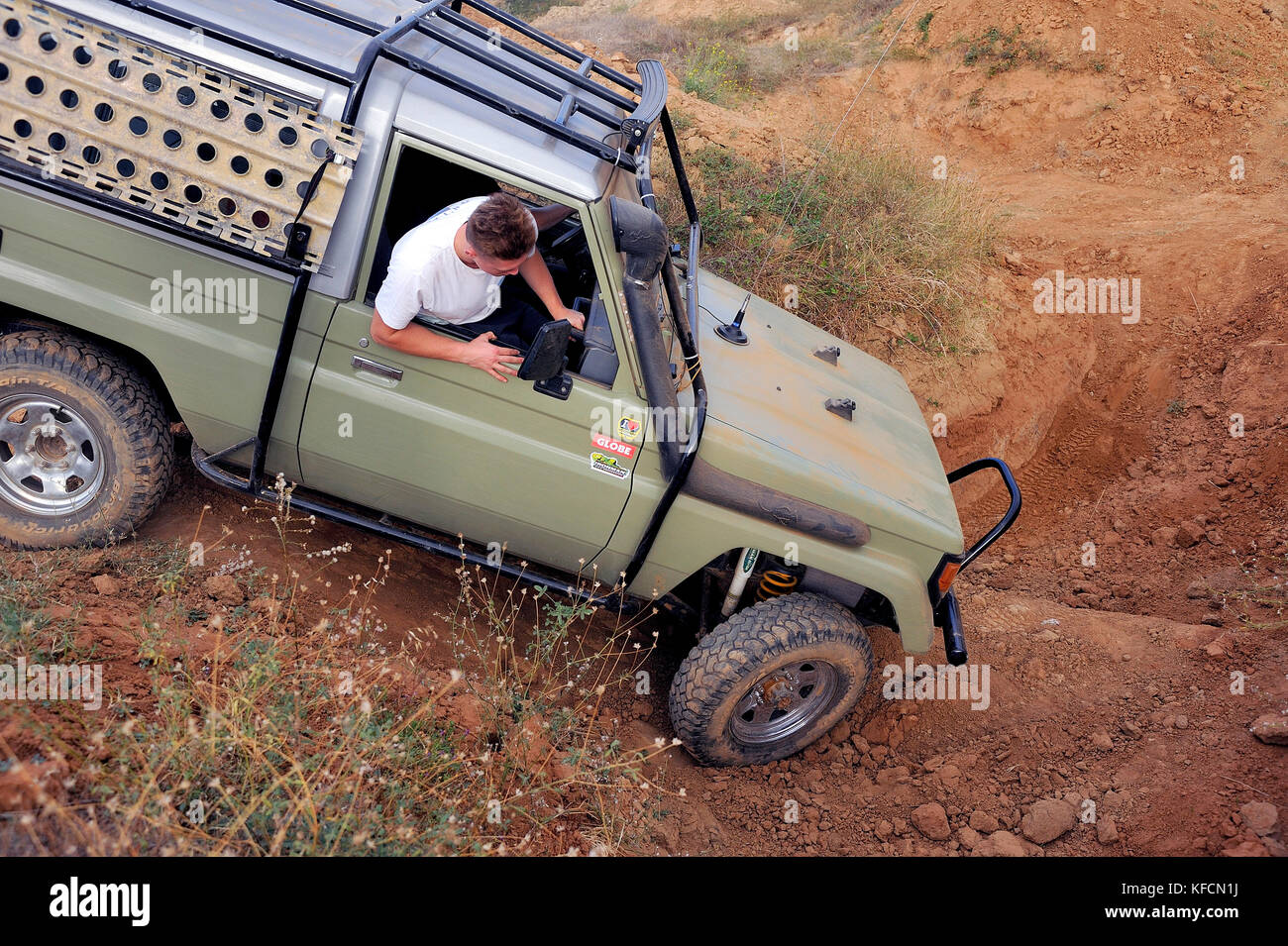 Large excavator digging hole sparks cars on trial grounds Stock Photo ...