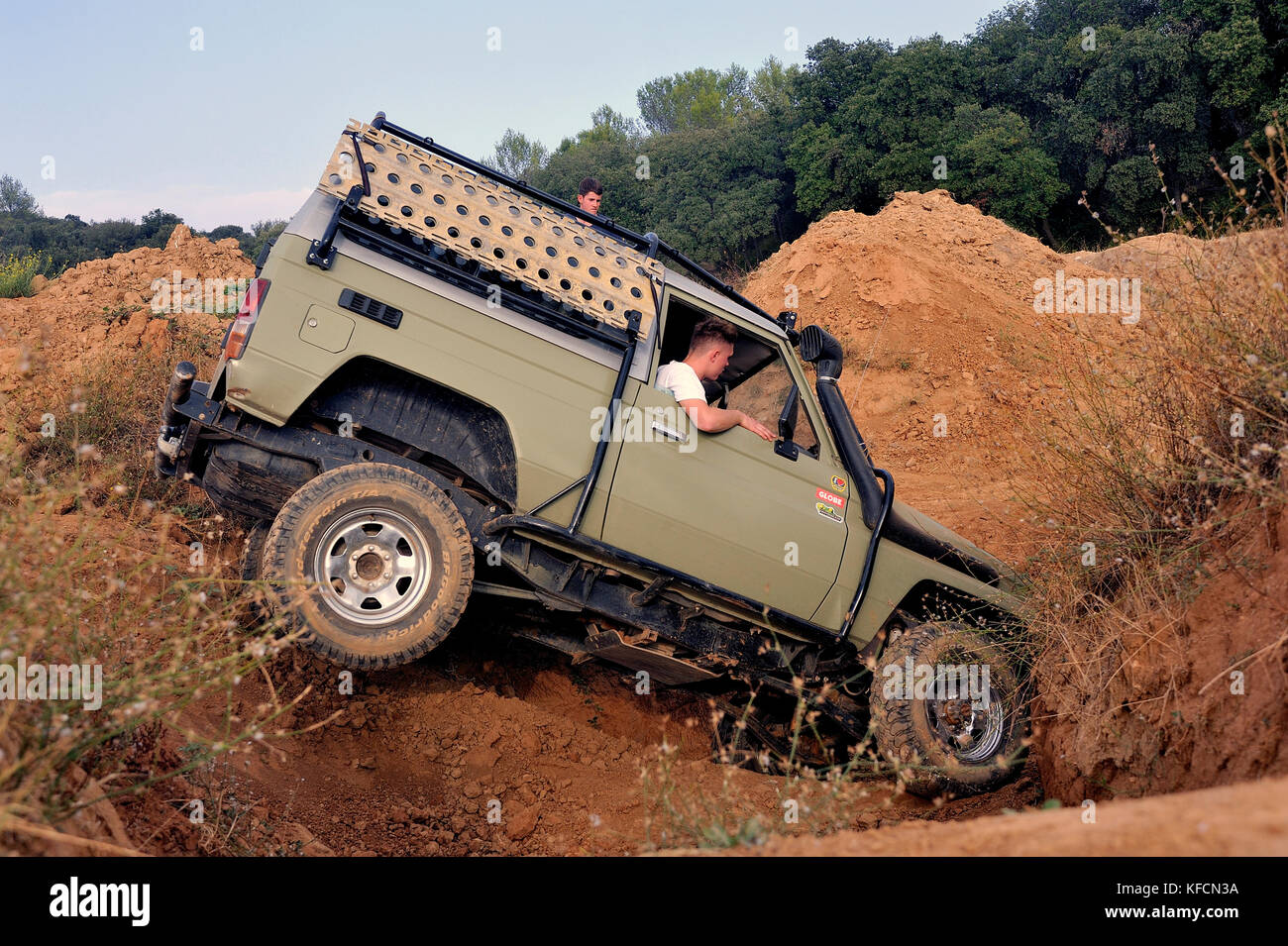 Large excavator digging hole sparks cars on trial grounds Stock Photo ...