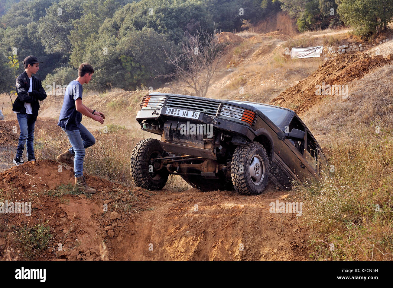 Large excavator digging hole sparks cars on trial grounds Stock Photo ...