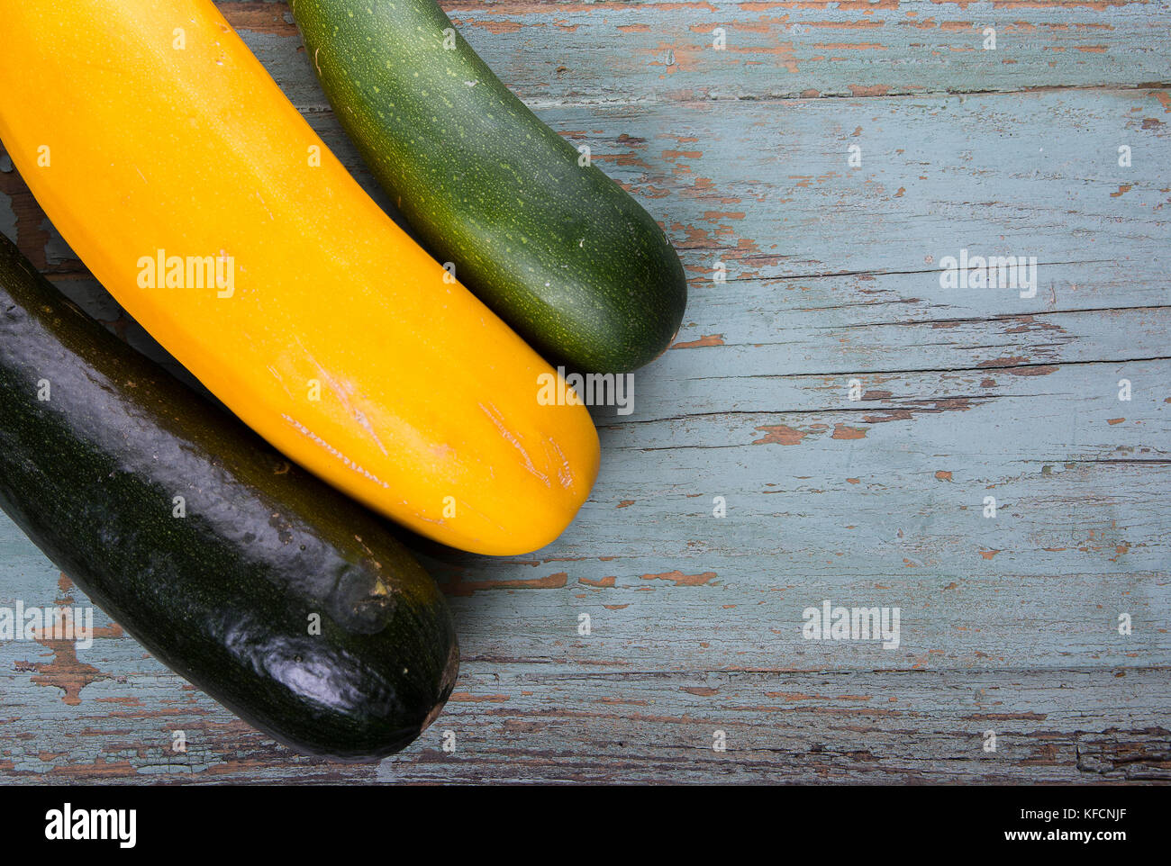 Different color vegetable zucchini on old grungy top Stock Photo - Alamy
