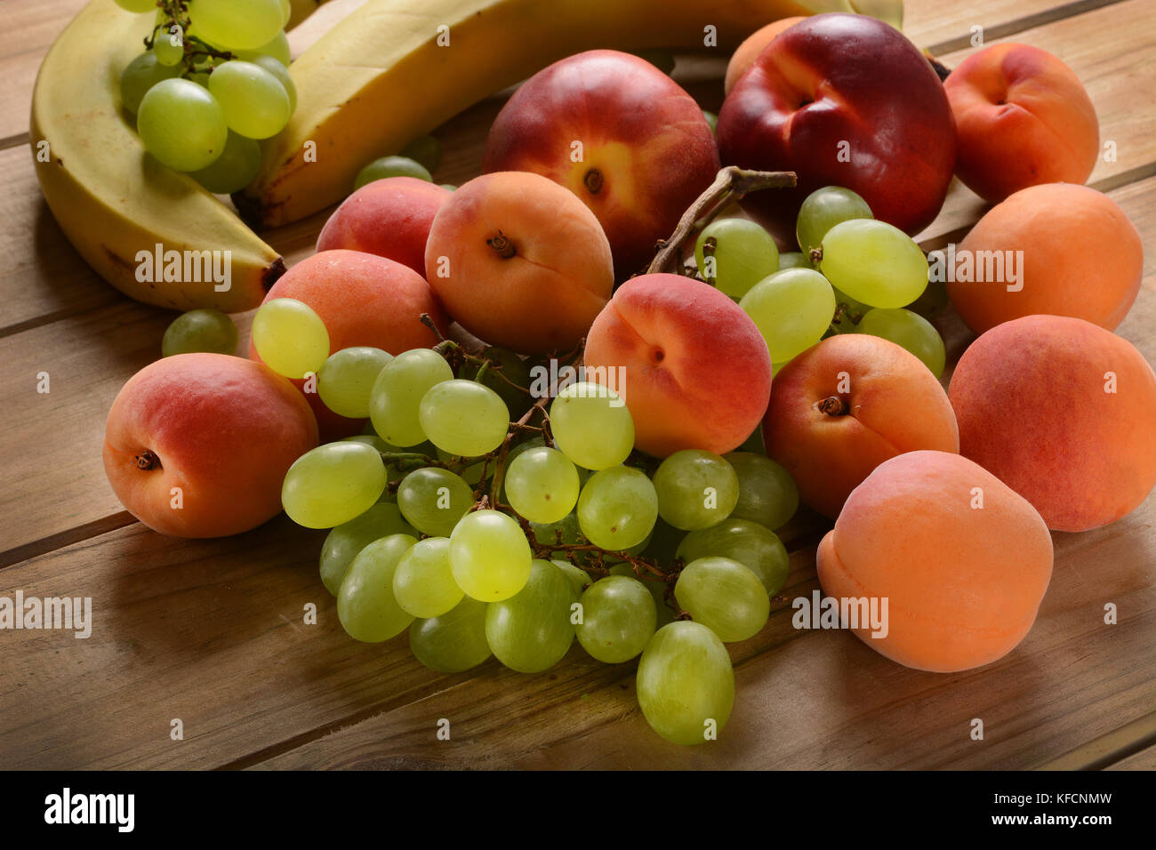 Assorted fruit on wooden table - closeup Stock Photo - Alamy