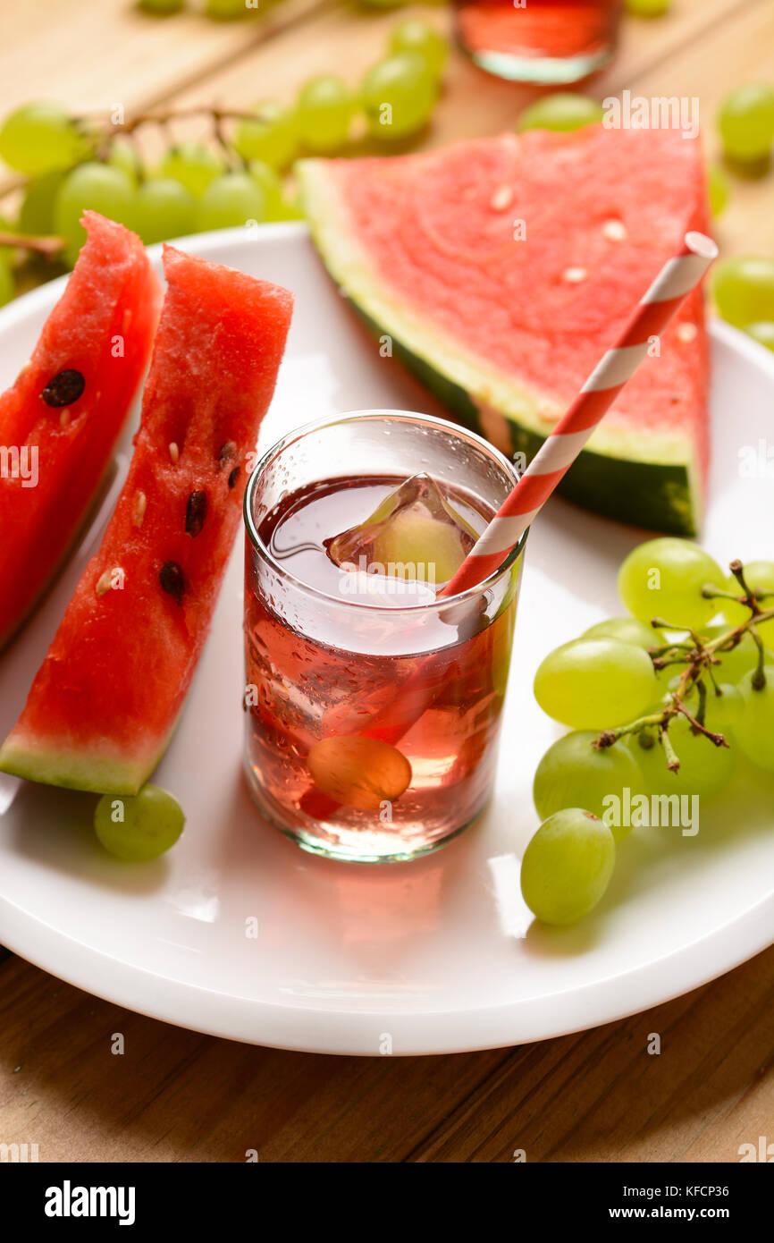A drink of watermelon and grapes with ice cubes - closeup Stock Photo ...