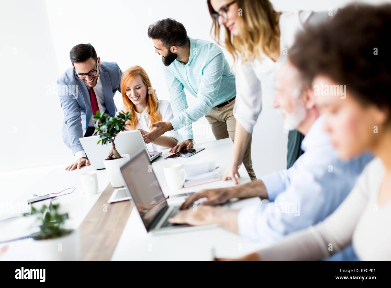View of multiracial business people around table during staff meeting ...