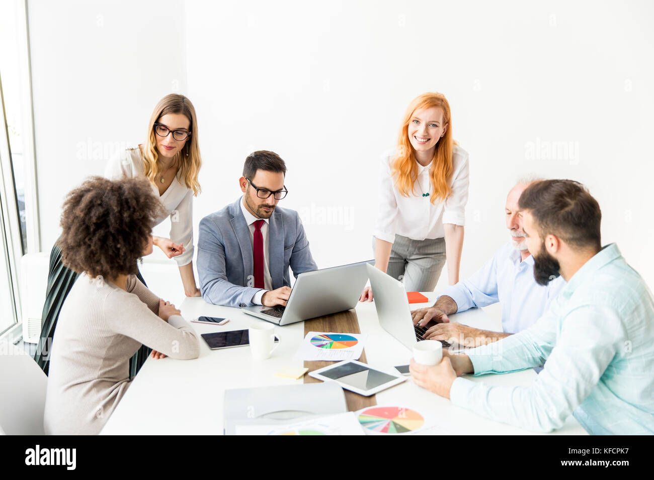 View of multiracial business people around table during staff meeting ...