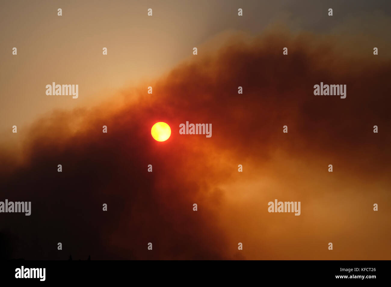 The sun is seen through thick smoke Stock Photo - Alamy
