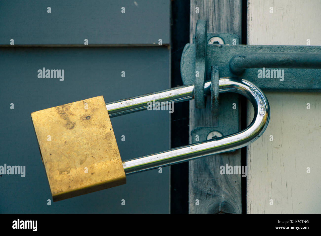 Closeup on big gold and silver lock locking doorknob Stock Photo - Alamy