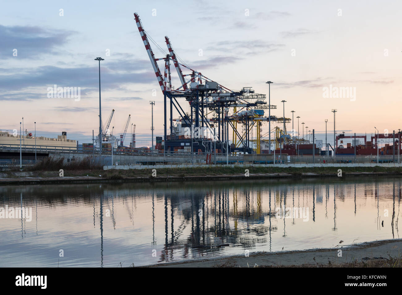Container Terminal, Shipyard and Cranes at Sunset and Their Reflection ...